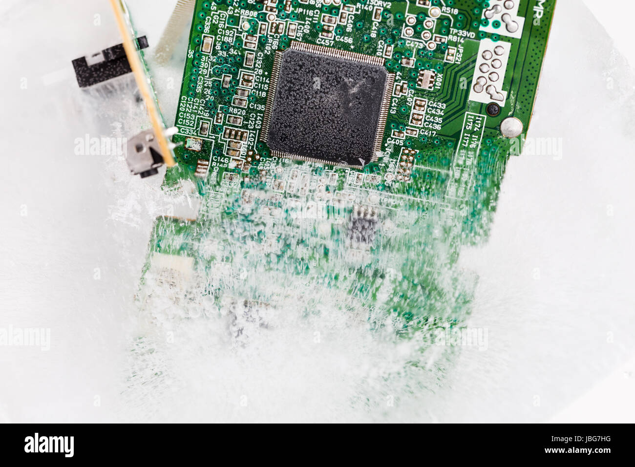 frozen electonics board for computer in ice Stock Photo - Alamy