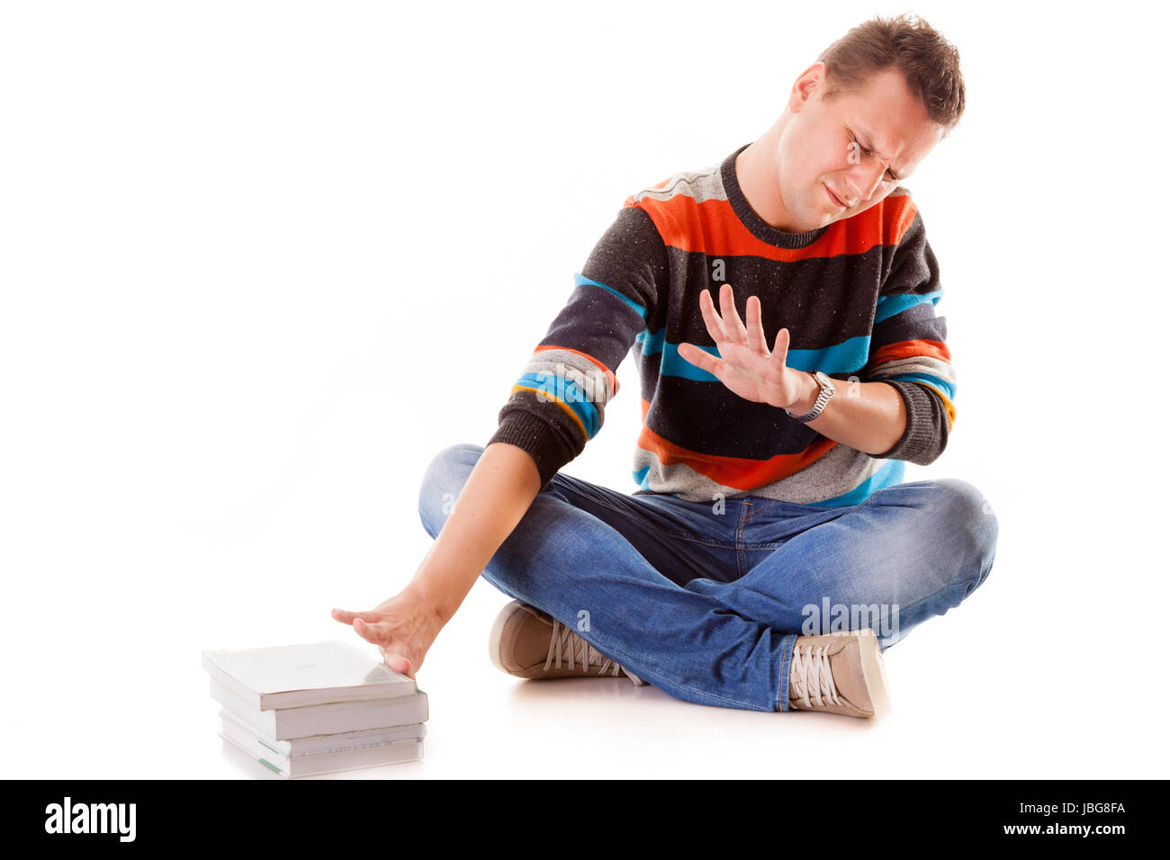 Exhausted tired college student with pile of books studying for exams ...