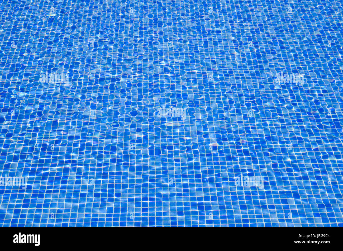 Blue pool water with sun reflections Stock Photo - Alamy