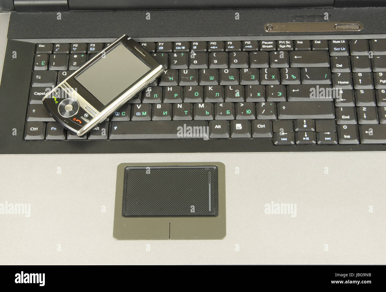 mobile isolated on a laptop Stock Photo - Alamy