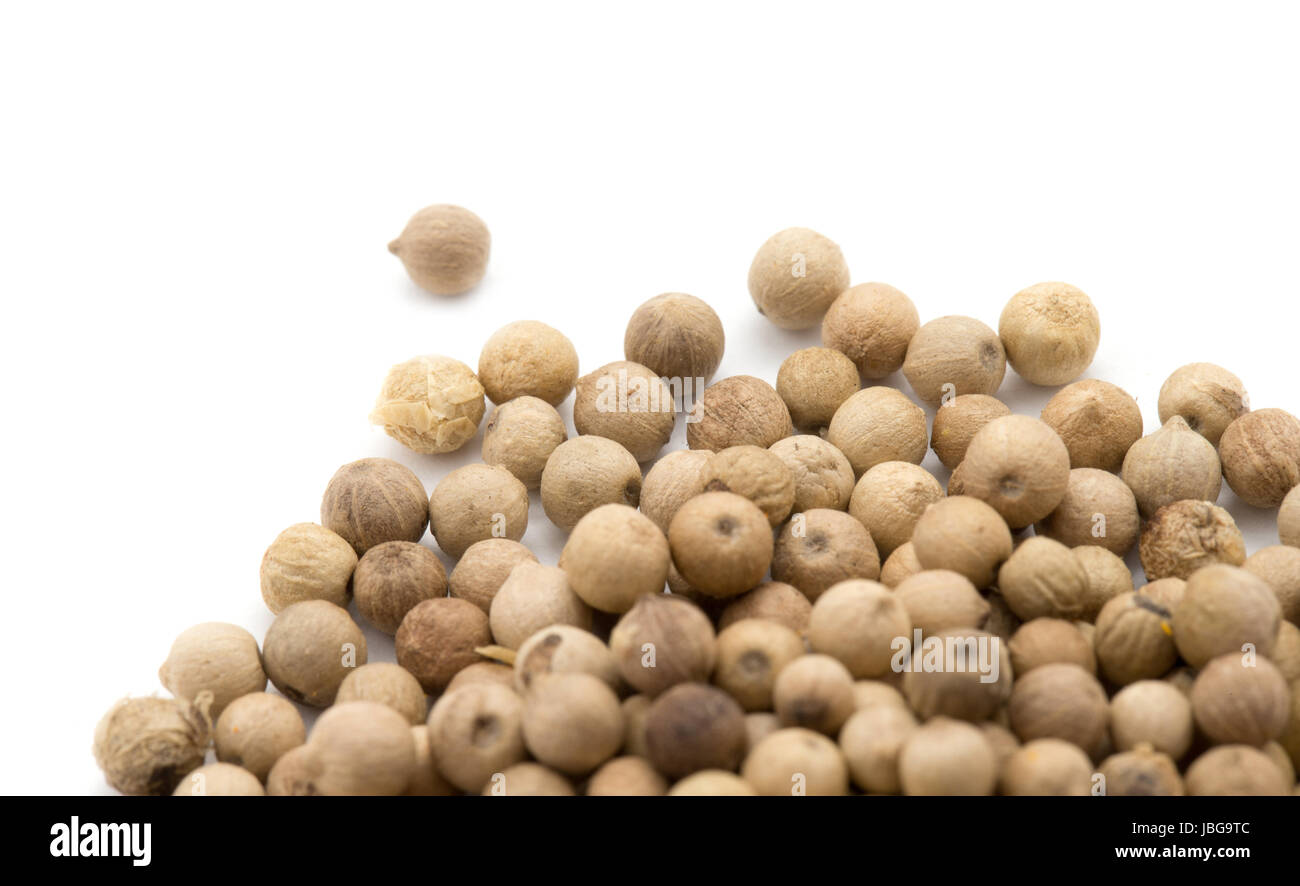 White pepper grains isolated on white background Stock Photo - Alamy