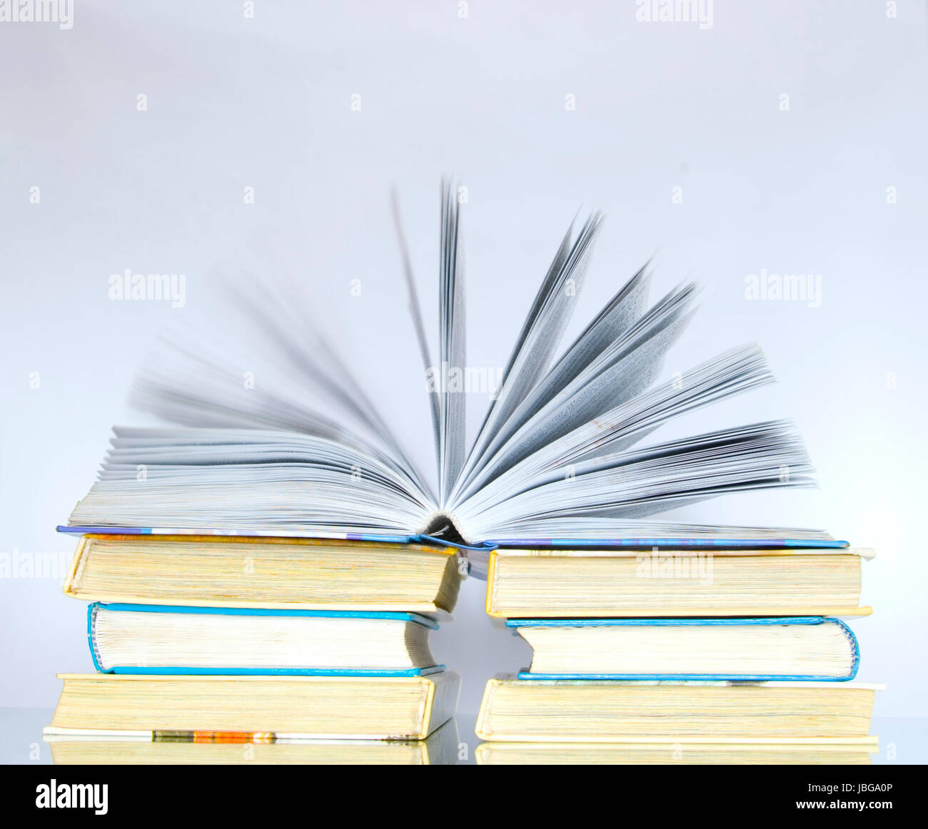 Pile of books over grey Stock Photo - Alamy