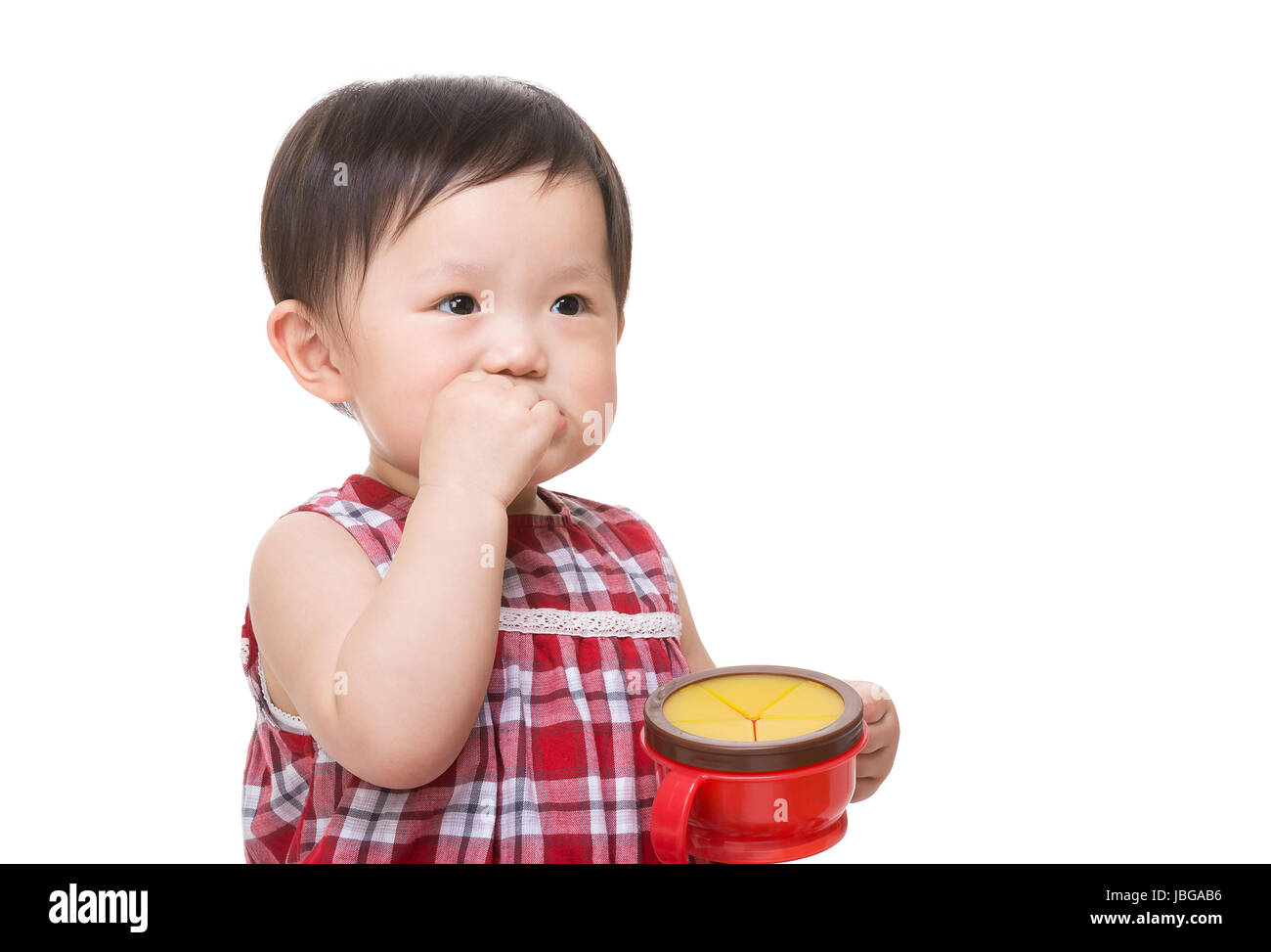 Asian little girl eating snack Stock Photo - Alamy