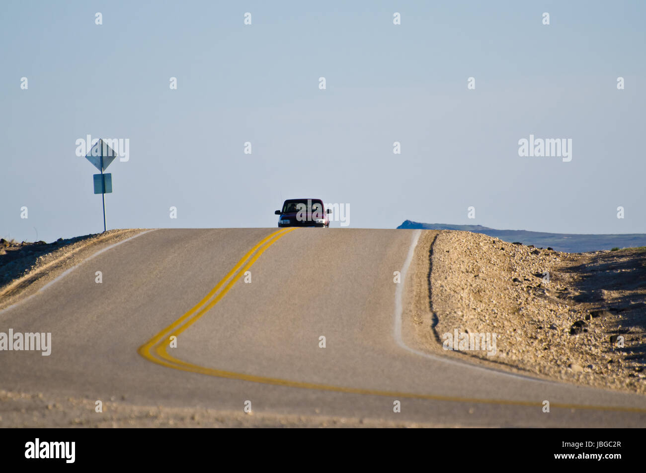 Car Approaching on a Desert Road Stock Photo - Alamy