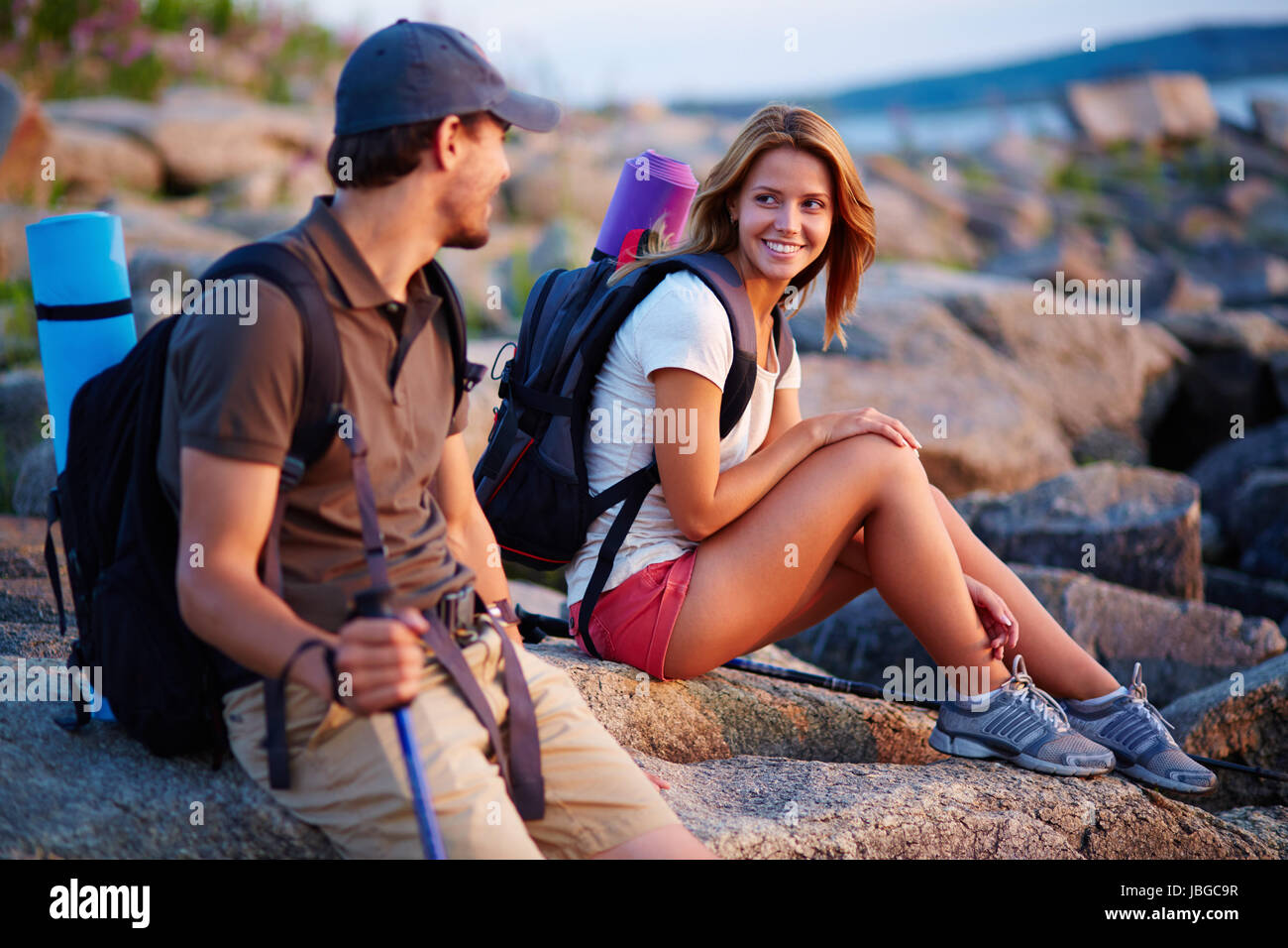 Pretty hiker looking at her boyfriend while talking to him Stock Photo ...
