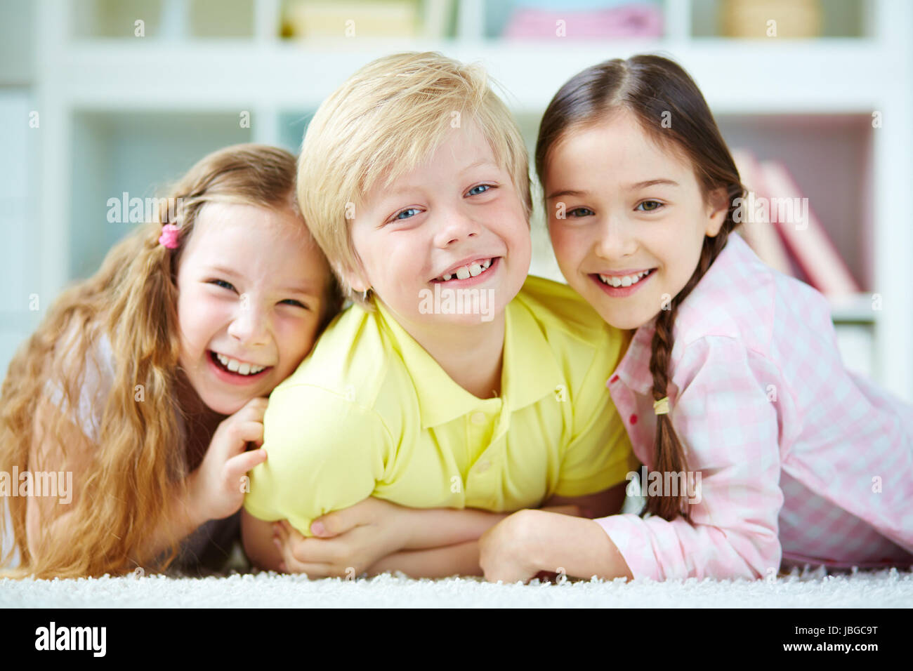 Three little friends looking at camera with smiles Stock Photo - Alamy
