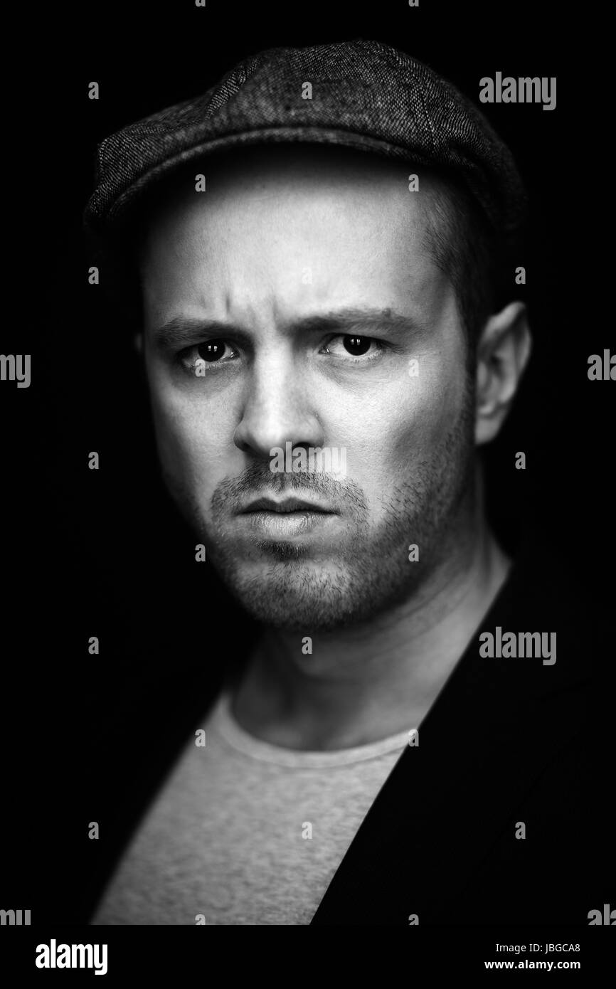 Vertical portrait of serious guy looking at camera Stock Photo - Alamy