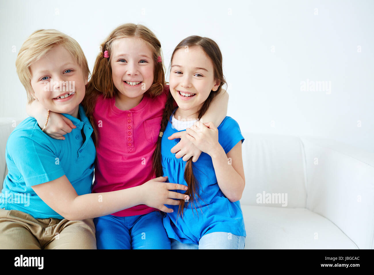 Three little friends looking at camera with smiles Stock Photo - Alamy