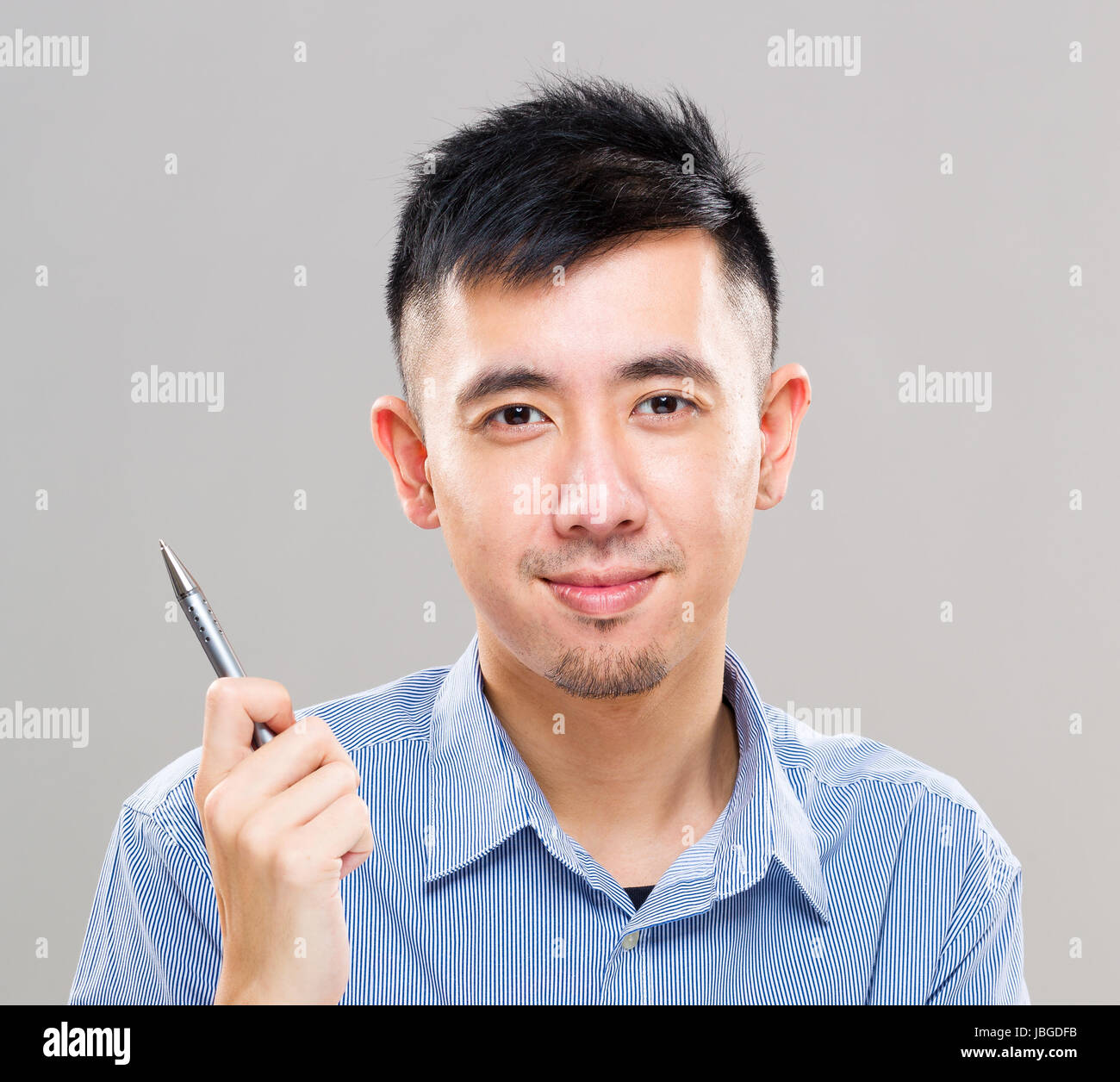 Young asian man holding pen Stock Photo - Alamy Young asian man holding pen Stock Photo - Alamy