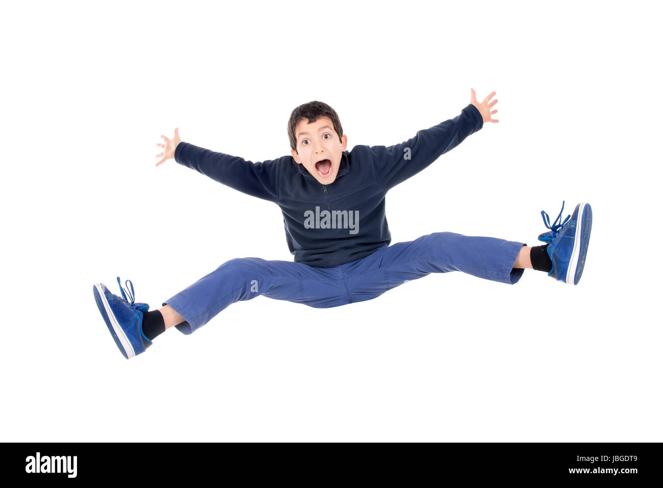 Young boy jumping isolated in white Stock Photo - Alamy
