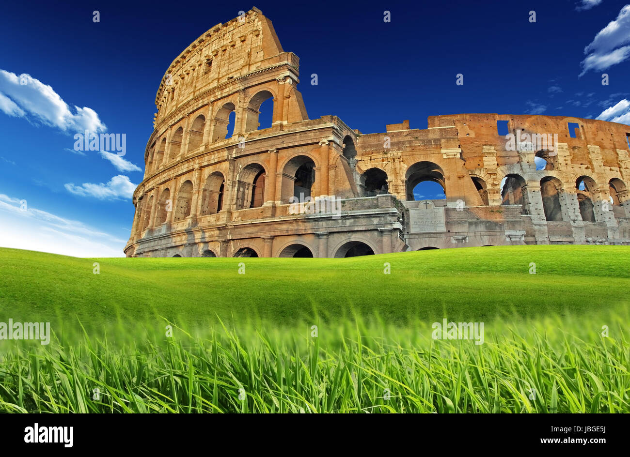 Ancient Rome: Colosseum in the grassland with blue sky and clouds in ...