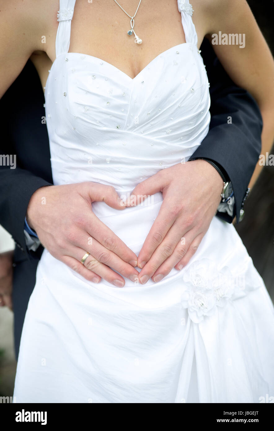 Wedding couple showing heart with their hands Stock Photo - Alamy