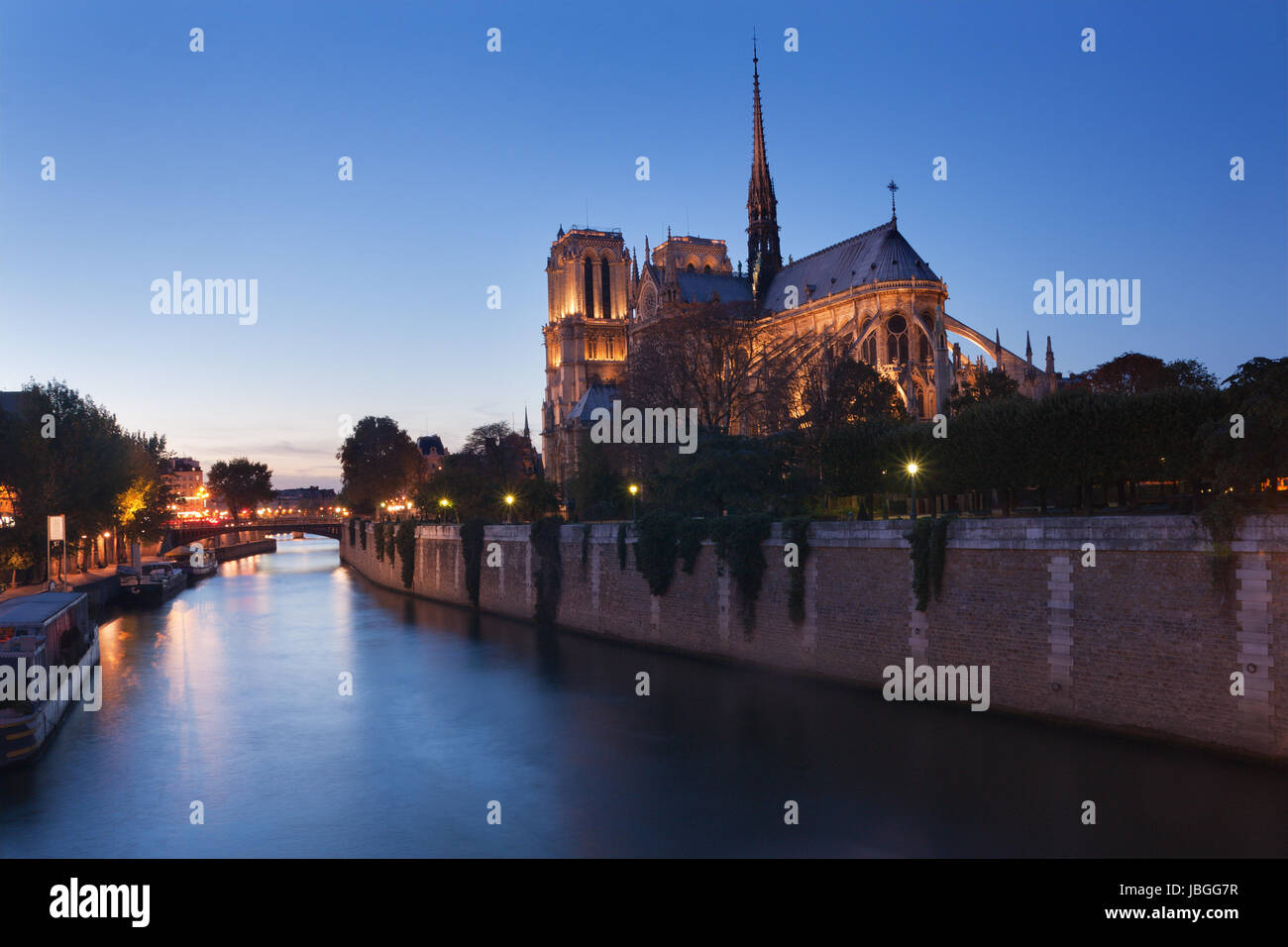 Rear view of Notre Dame cathedral in Paris, France, at dusk Stock Photo ...