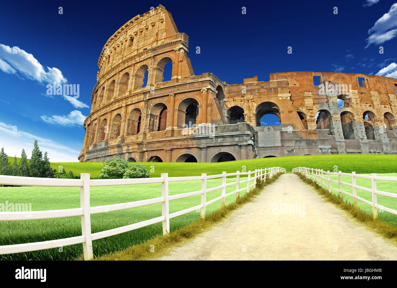 Ancient Rome: Colosseum in the grassland with country road and blue sky ...