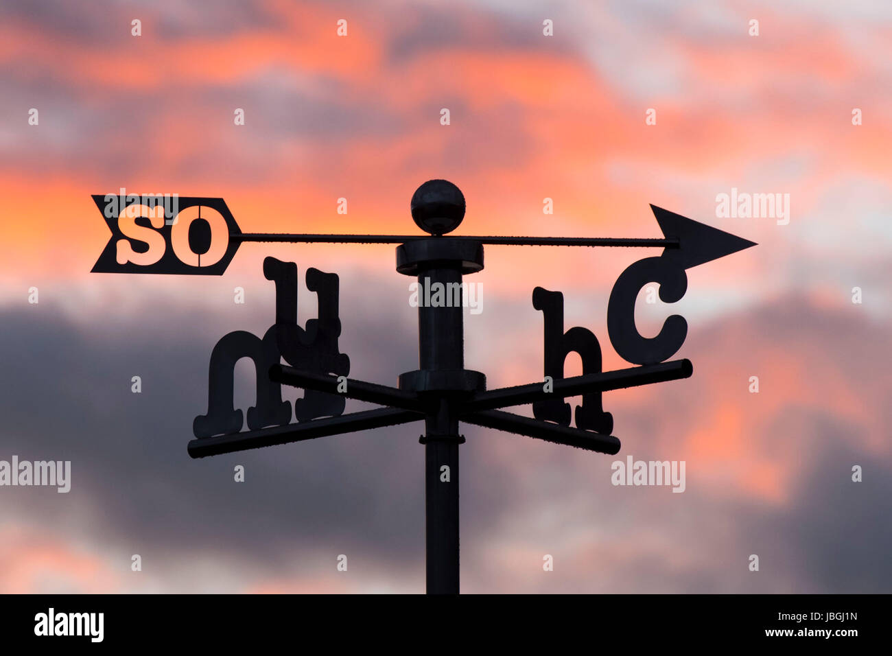 A compass silhouette seen at sunrise/sunset Stock Photo - Alamy