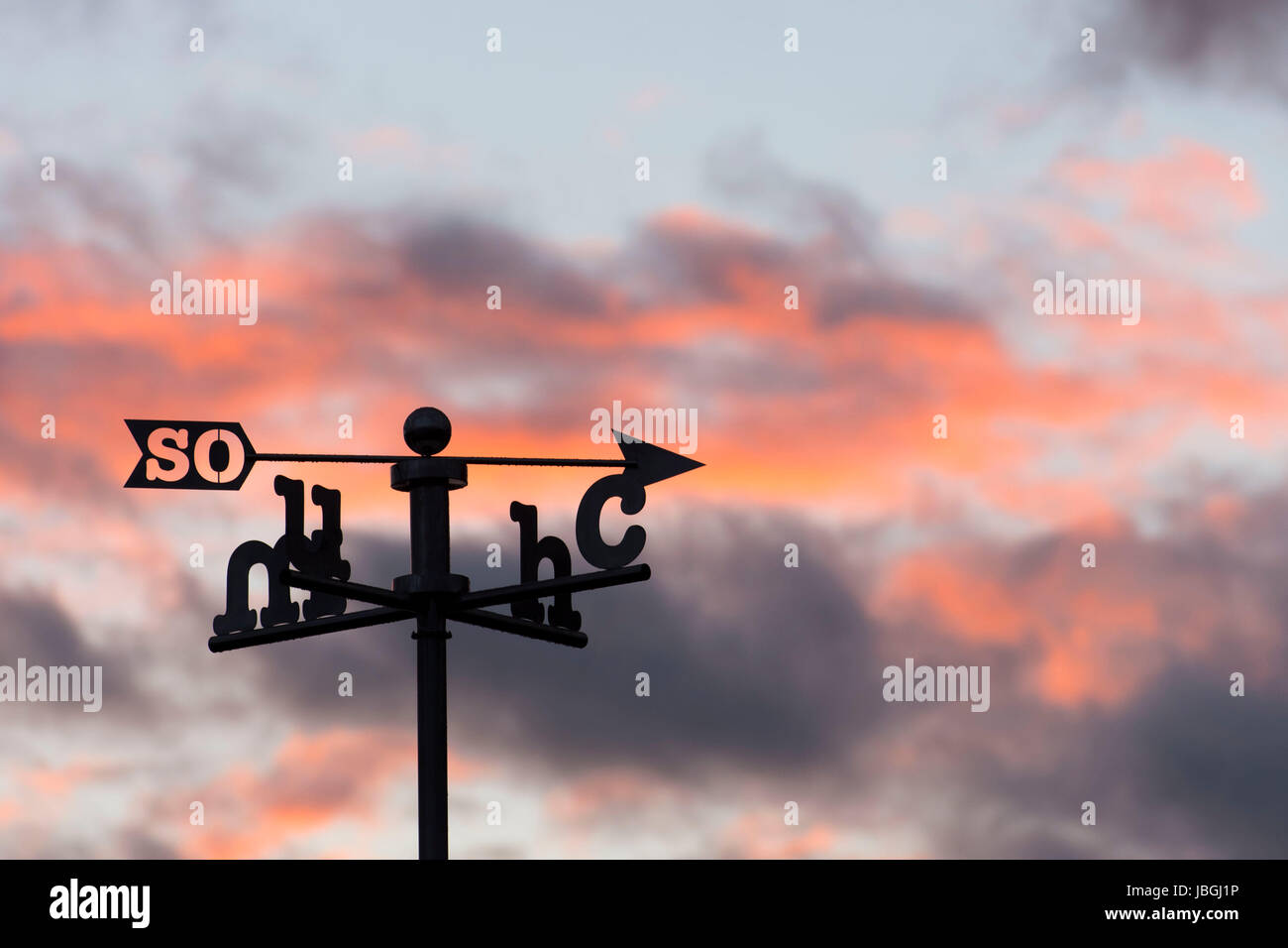 A compass silhouette seen at sunrise/sunset Stock Photo - Alamy