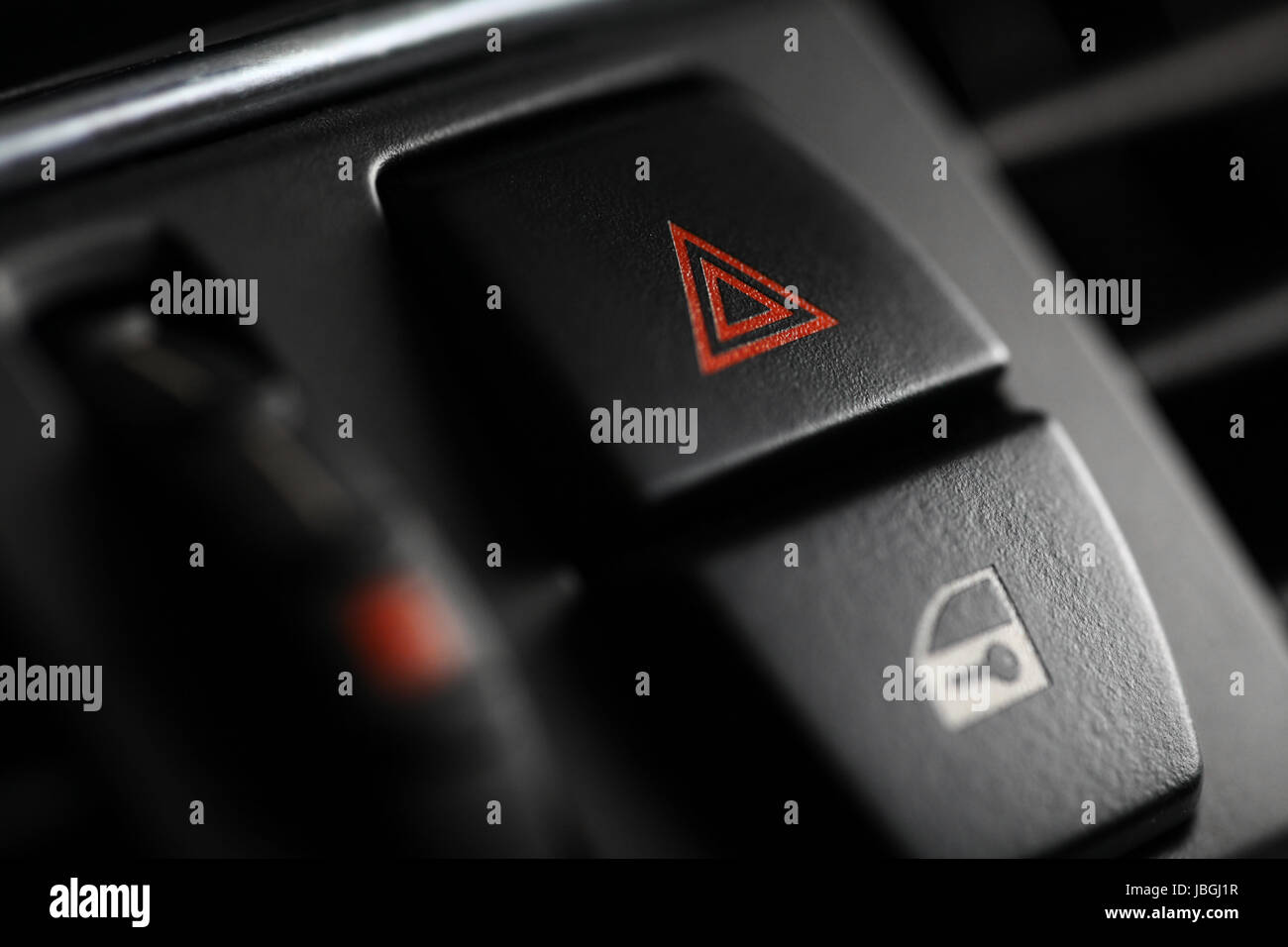 Detail of a warning button in a car Stock Photo - Alamy
