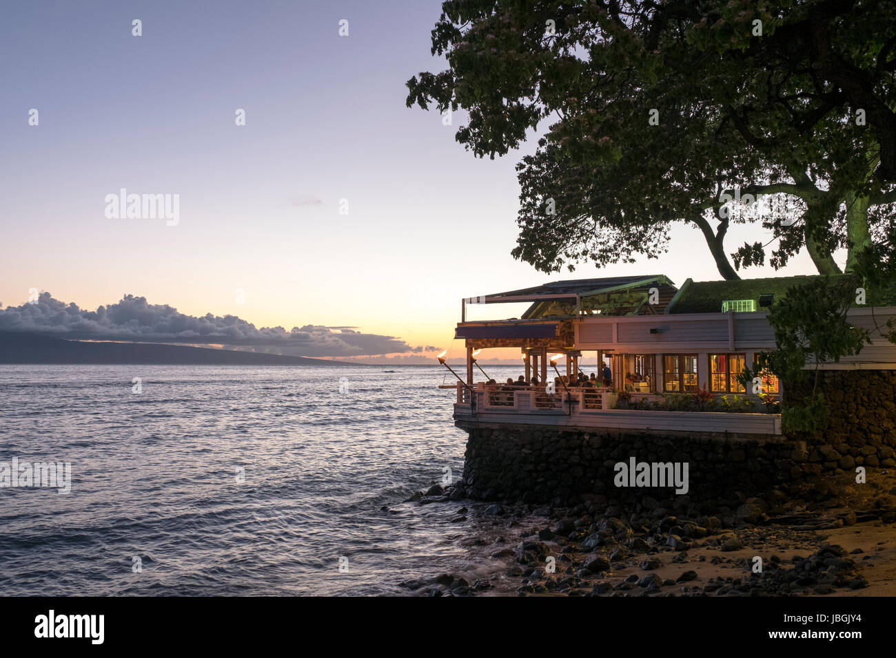 Tourists enjoying a sunset dinner in a restaurant on Front Street ...
