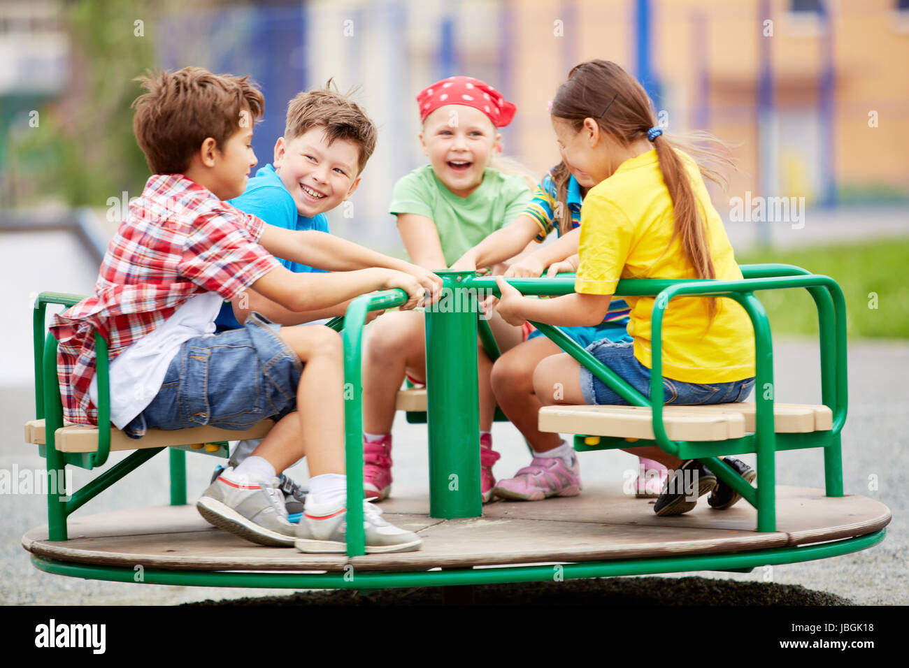 Image of joyful friends having fun on carousel outdoors Stock Photo - Alamy