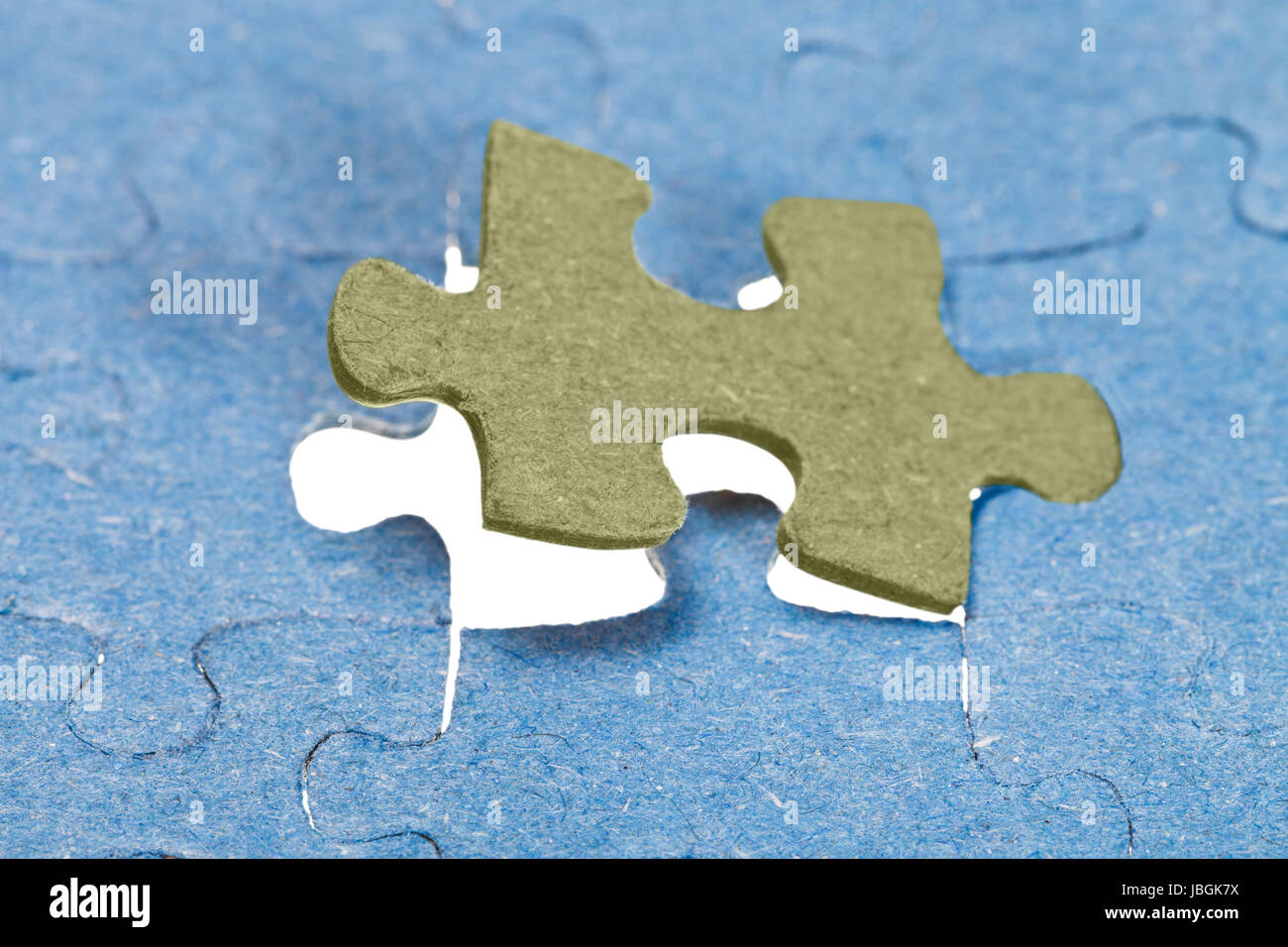 fitting the last piece of puzzle in free space in assembled jigsaw ...