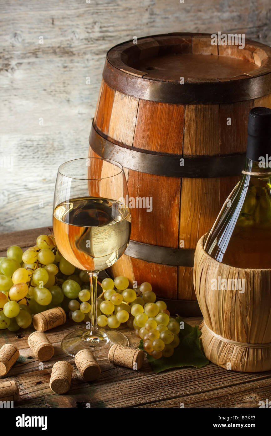 Still life with wine bottle, glass and barrel Stock Photo - Alamy