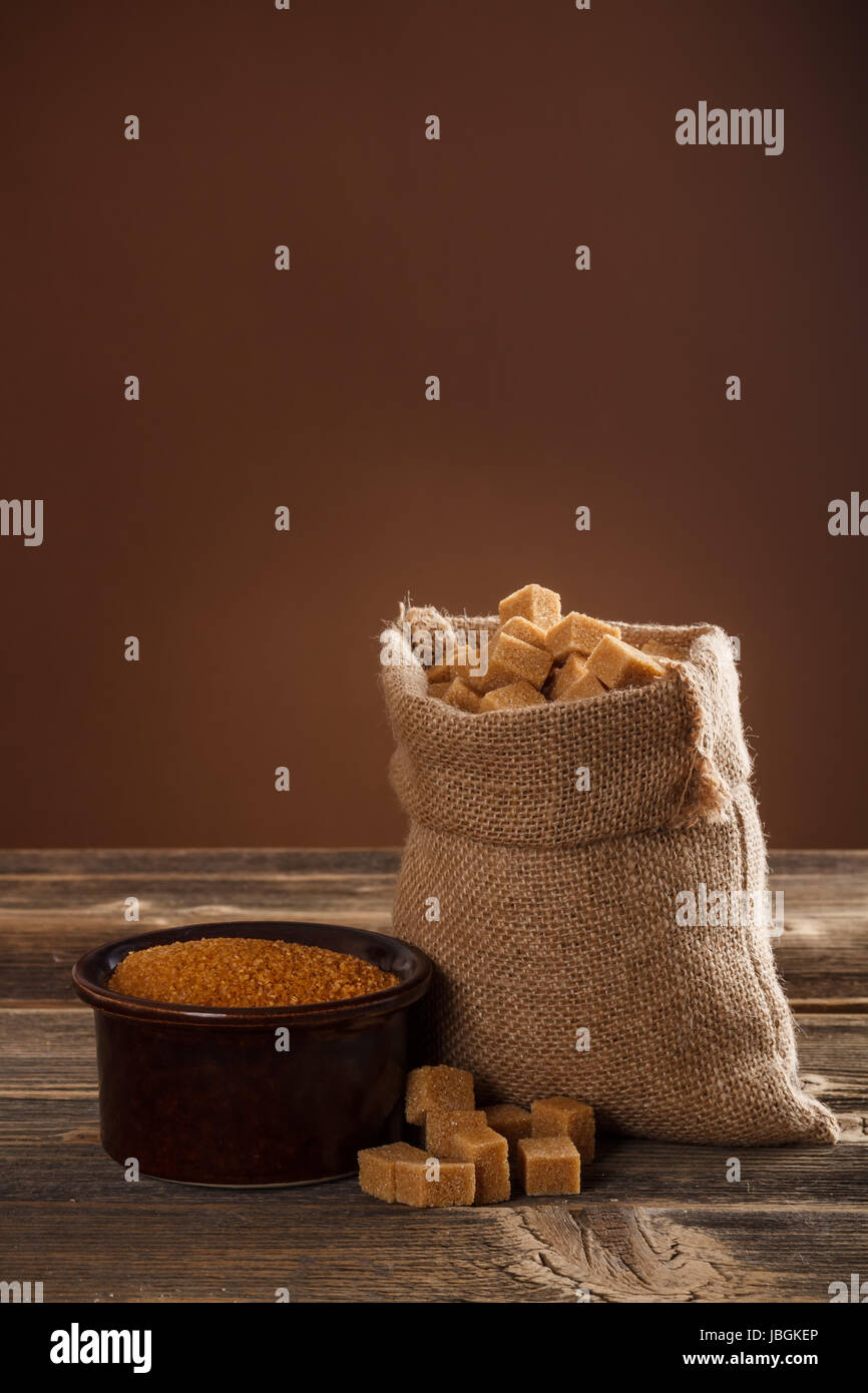 Brown sugar bowl and lump sugar in burlap sack Stock Photo - Alamy