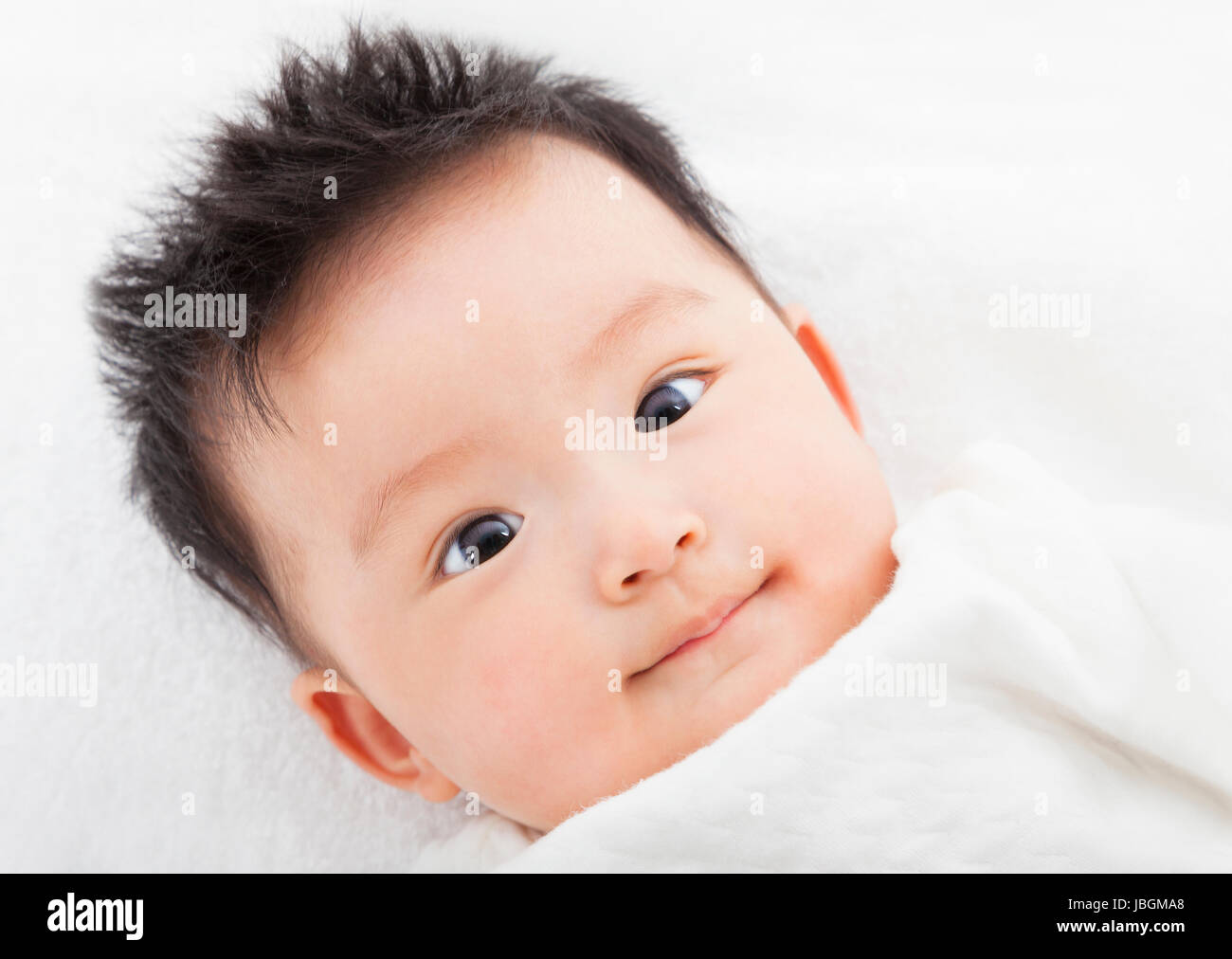 A cute and smiling little baby is looking into the camera Stock Photo ...