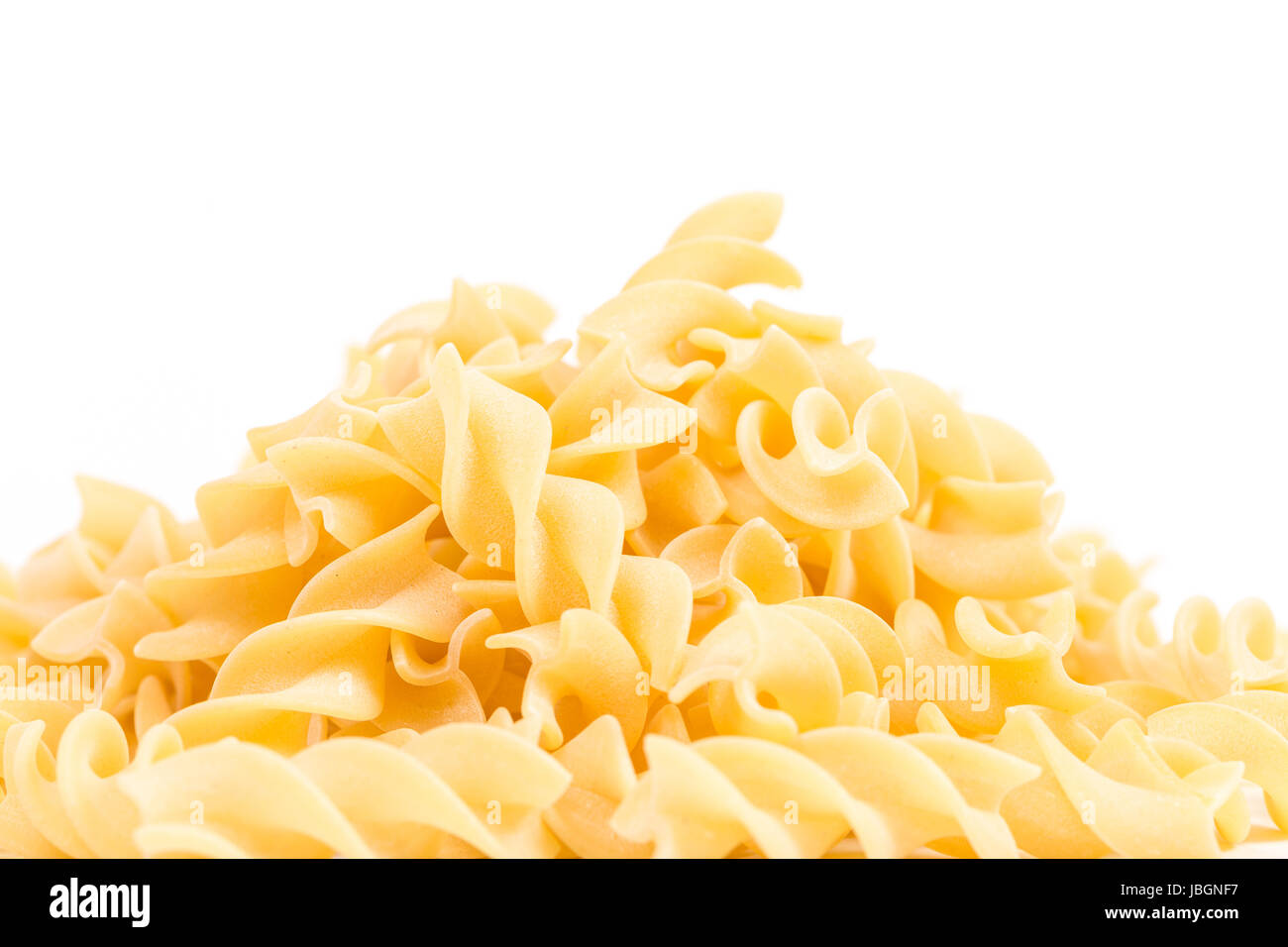 Three fusilli dry pasta isolated on white background Stock Photo - Alamy