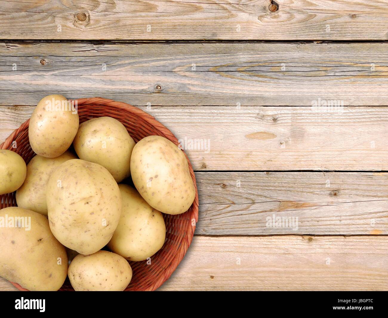 Potatoes on wooden background Stock Photo - Alamy