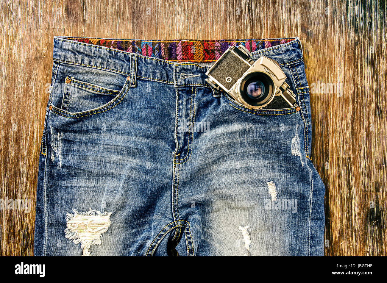 Detail of vintage jeans with classic camera in the pocket Stock Photo ...