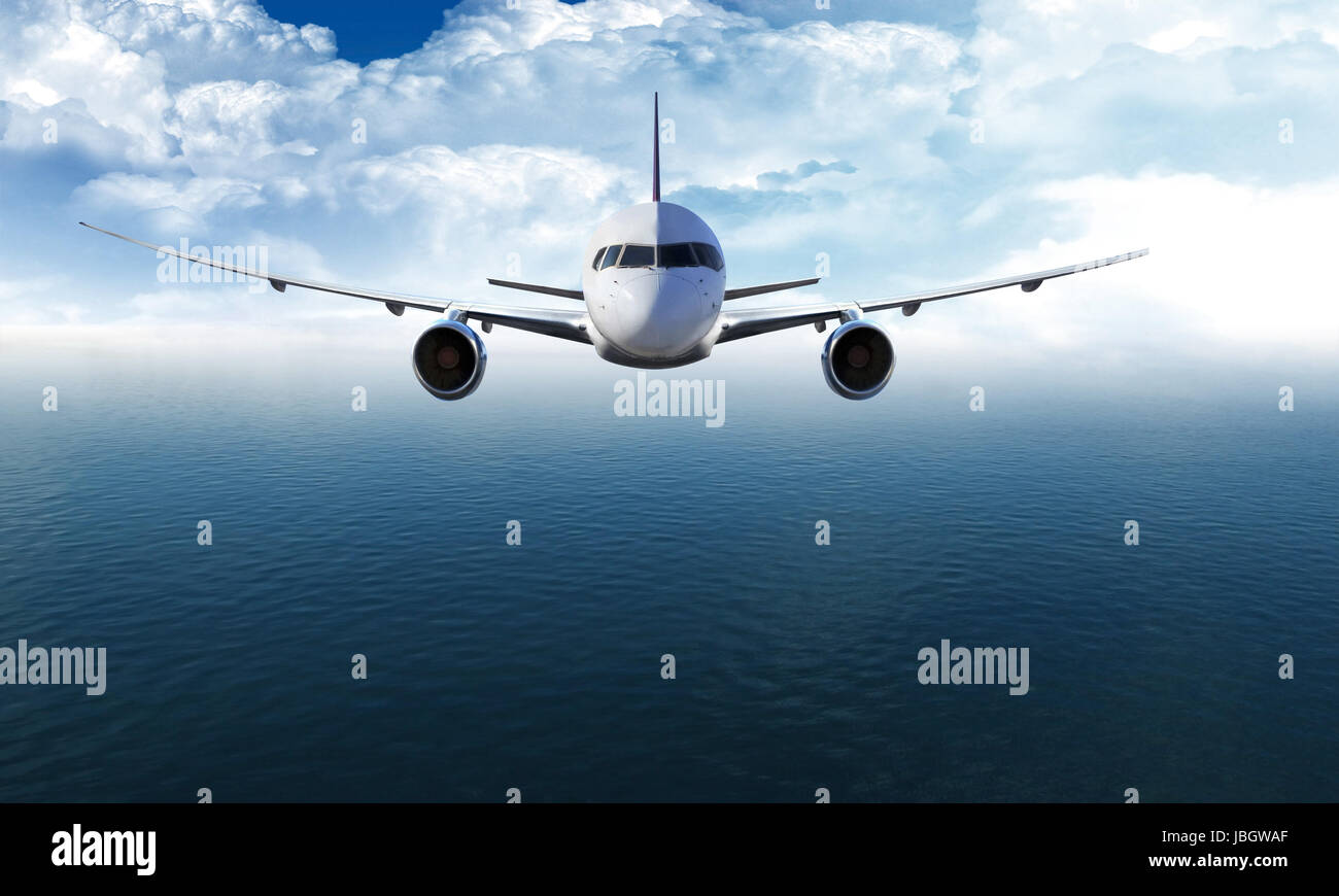 Airplane is flying over the ocean with blue sky and clouds in the ...