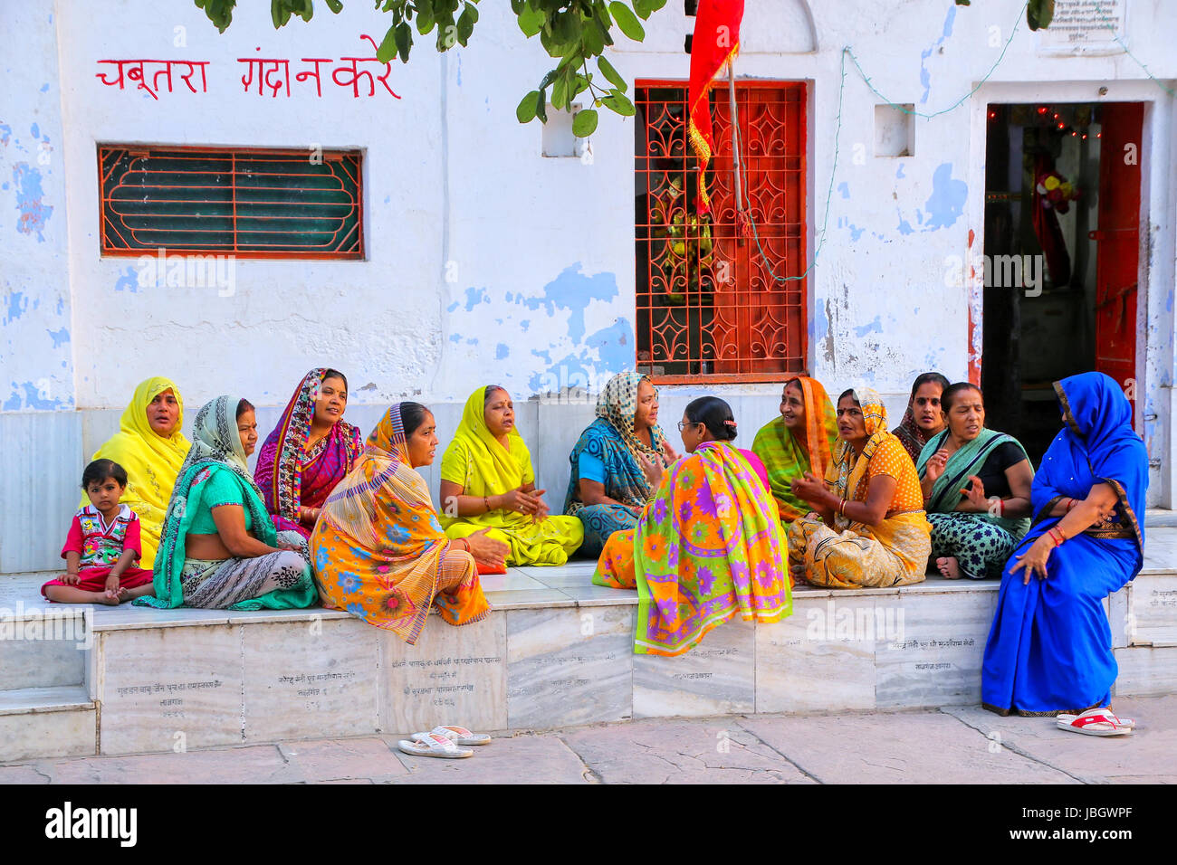 Local women sitting outside hindu temple in Taj Ganj neighborhood of ...