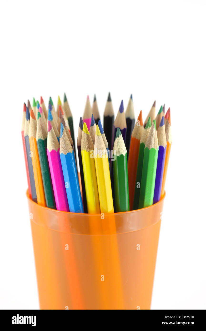 Color pencils in the orange prop over white. Shallow DOF Stock Photo ...