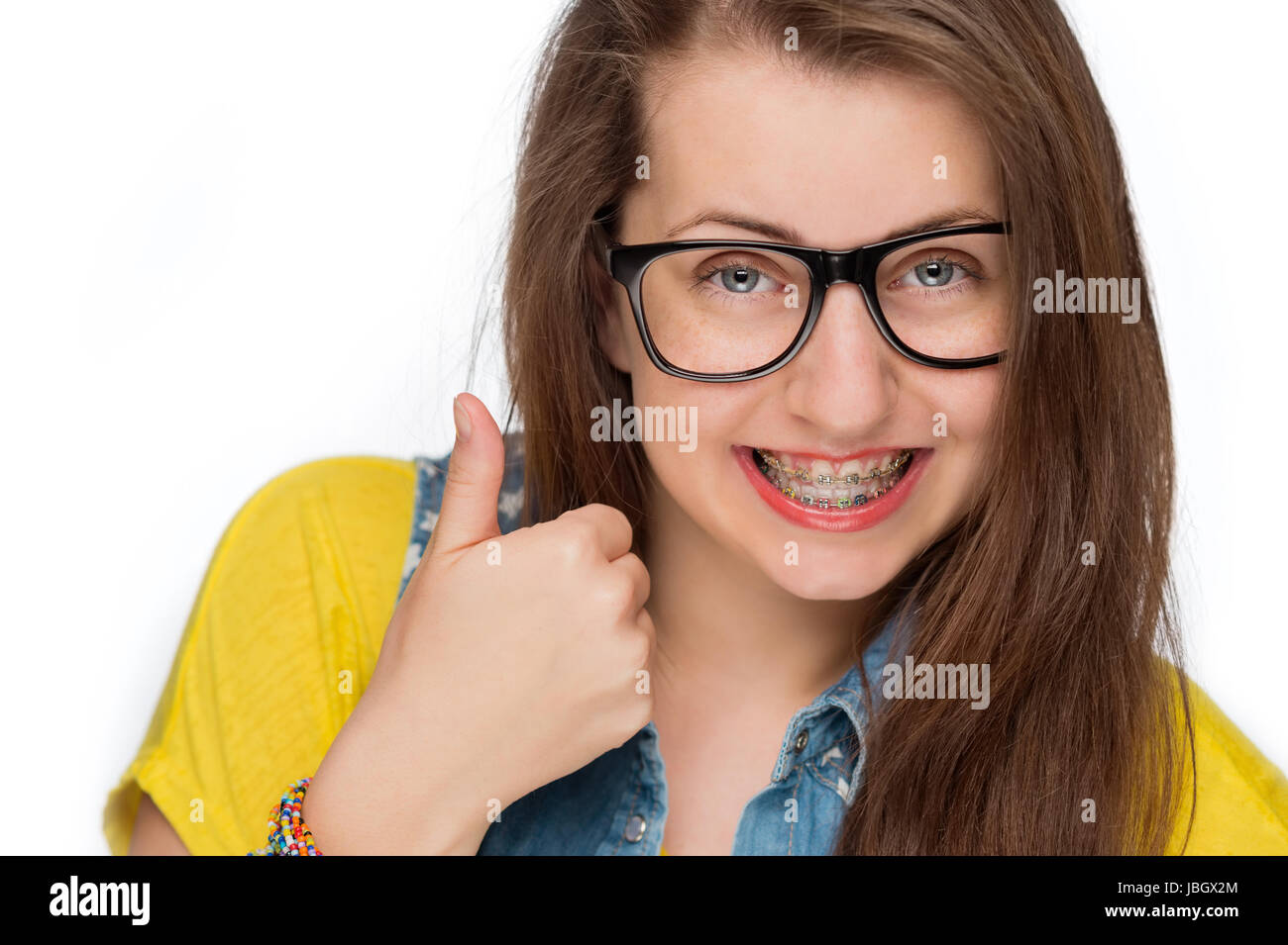 Girl with braces wearing geek glasses showing thumb up isolated Stock ...