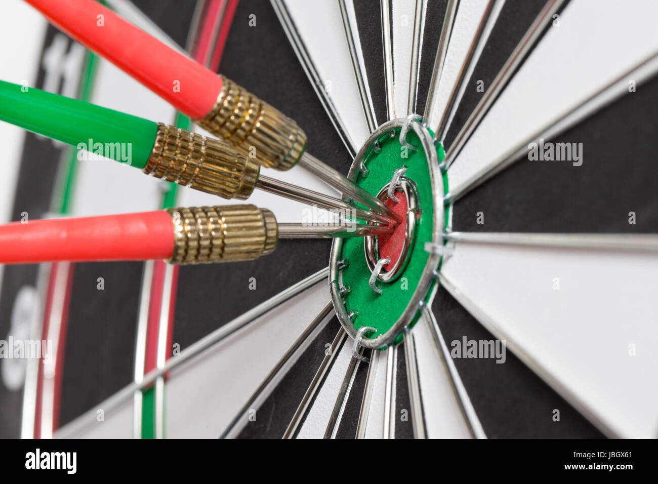 darts arrows in the target center Stock Photo - Alamy