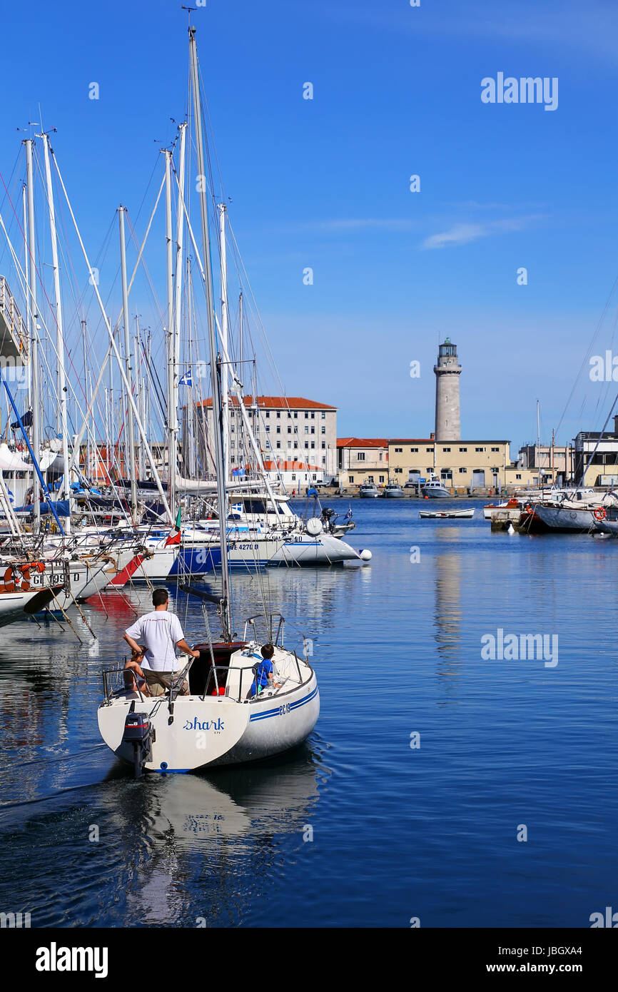 Boat marina and lighthouse in Trieste, Italy. Trieste is the capital of ...