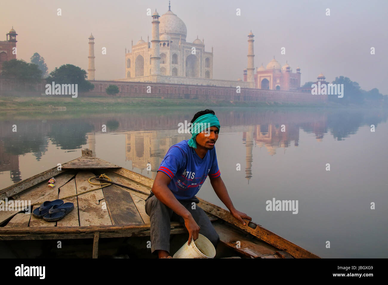 Local man bailing water out of the boat on Yamuna River near Taj Mahal ...
