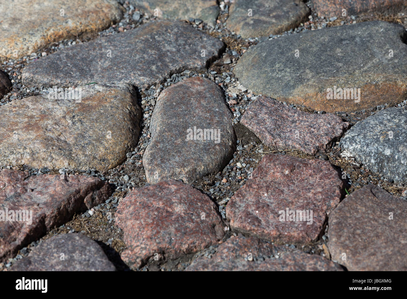 Granite old stone road texture as a background Stock Photo - Alamy