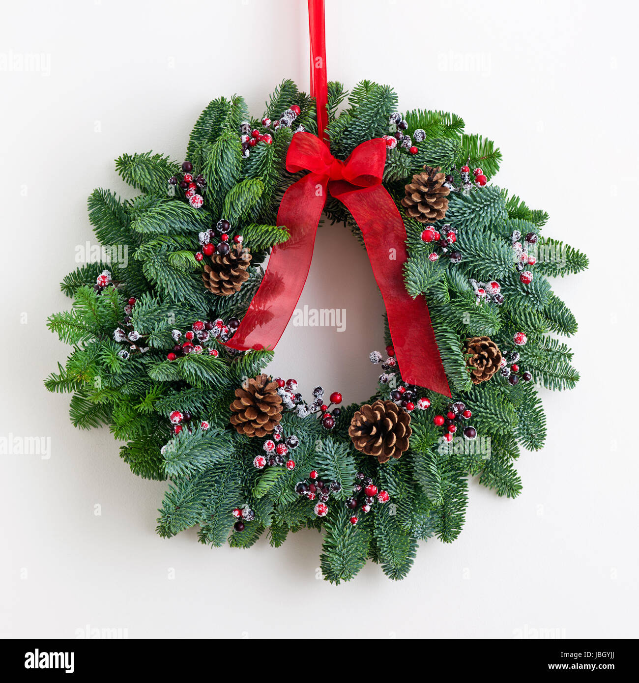 Advent wreath with red ribbon over bright wall Stock Photo - Alamy