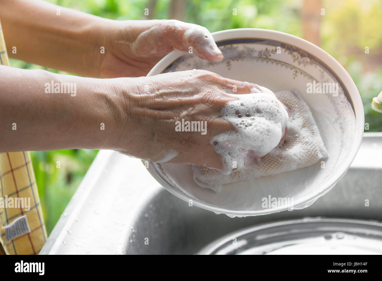 Close up hands of woman washing dishes in the kitchen Stock Photo - Alamy