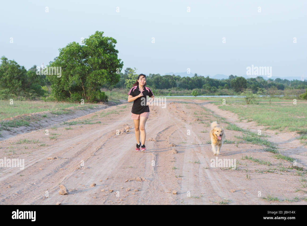 Happy young woman jogging with her beagle dog Stock Photo - Alamy
