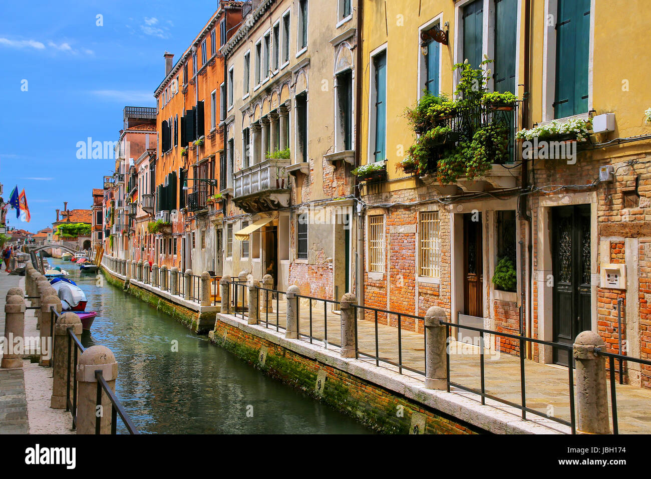 Row of houses along narrow canal in Venice, Italy. Venice is situated ...