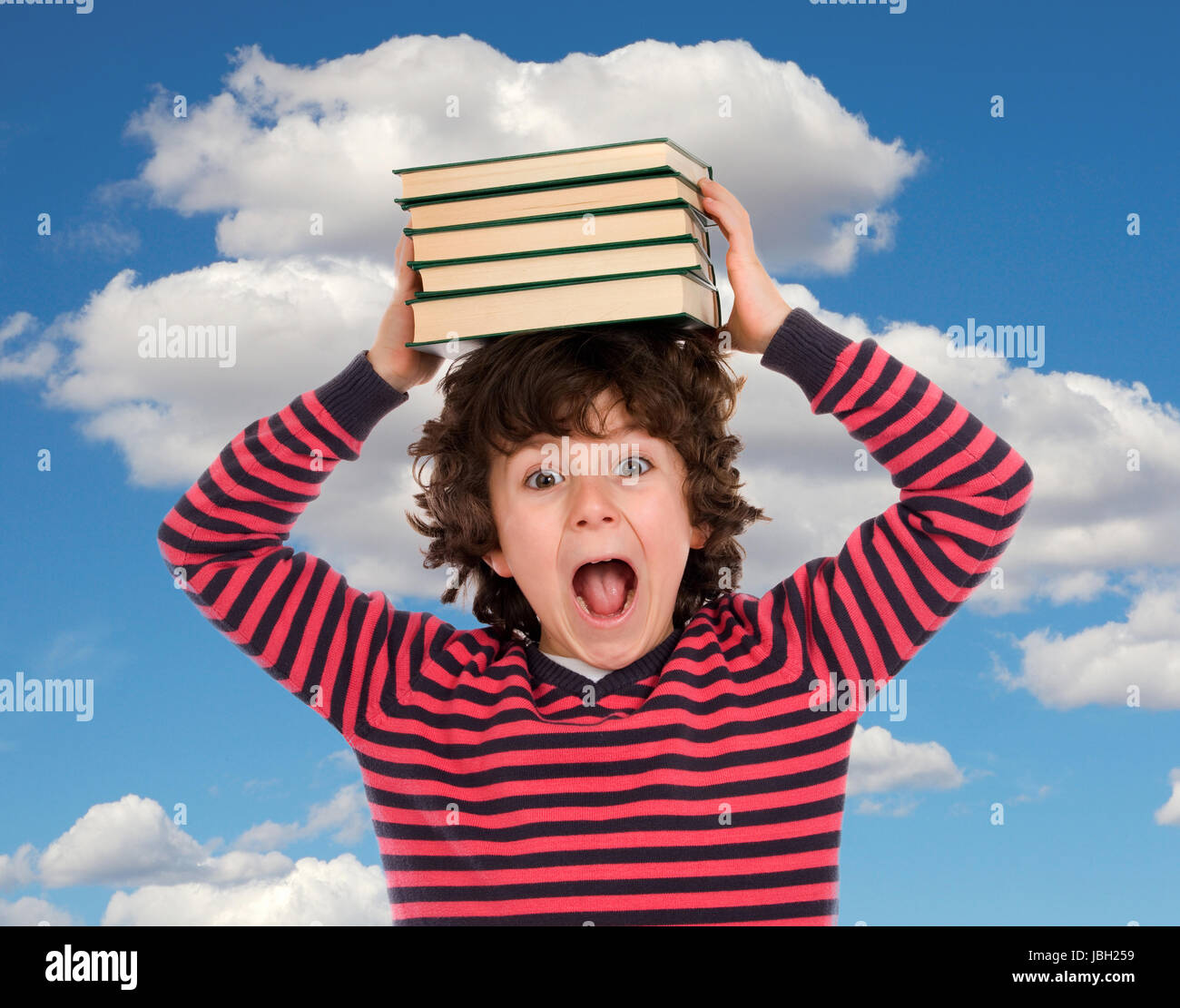 Crazy child shouting with books on the head Stock Photo - Alamy