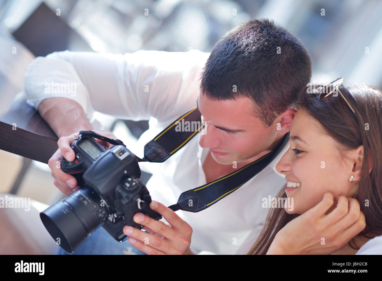 happy young romantic couple looking photos on camera Stock Photo - Alamy