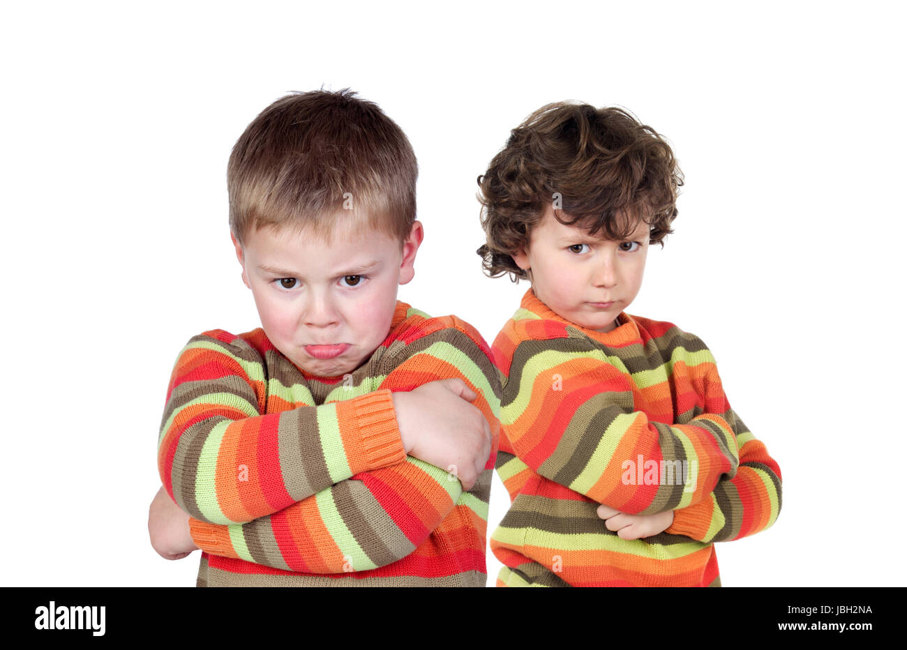 Two children with the same jersey angry isolated on a white background ...