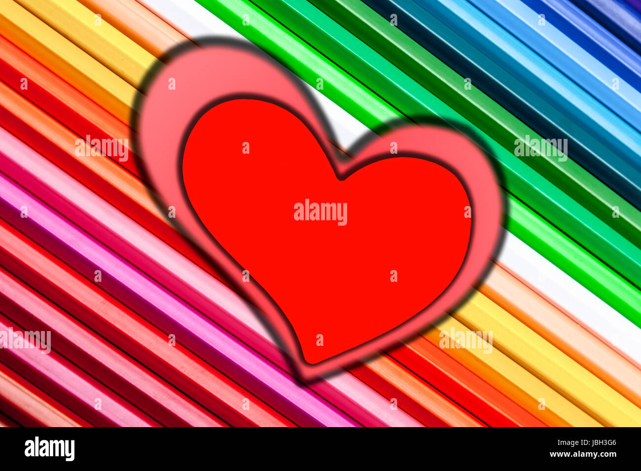 Heart shape on a composition of pencils of wood in a variety of colors ...