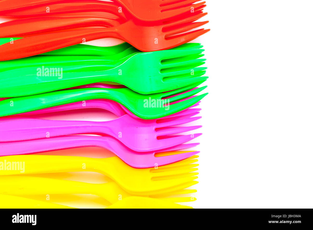 Multi colored plastic cutlery on a white background Stock Photo - Alamy