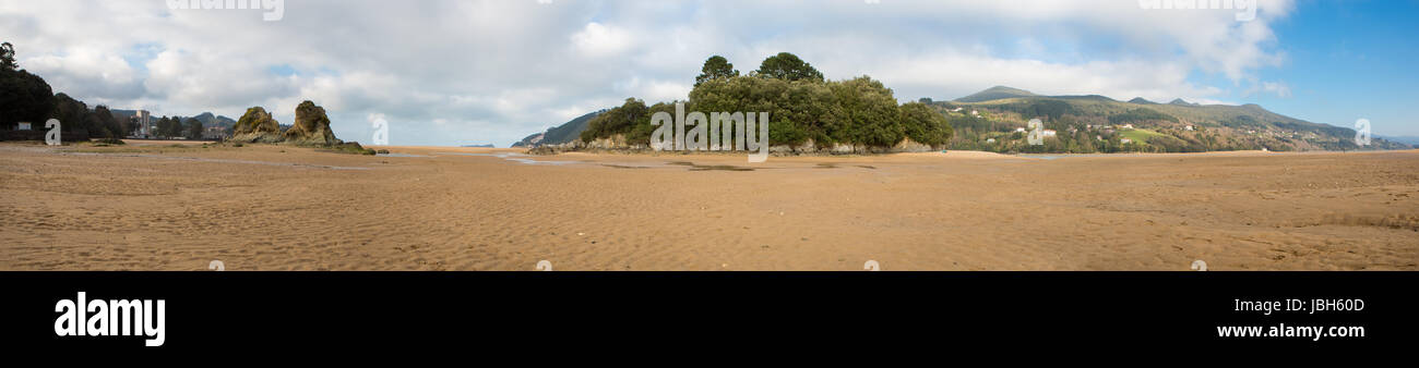 Panorama of the beach in Mundaka, Spain. Bright blue sky and the ...