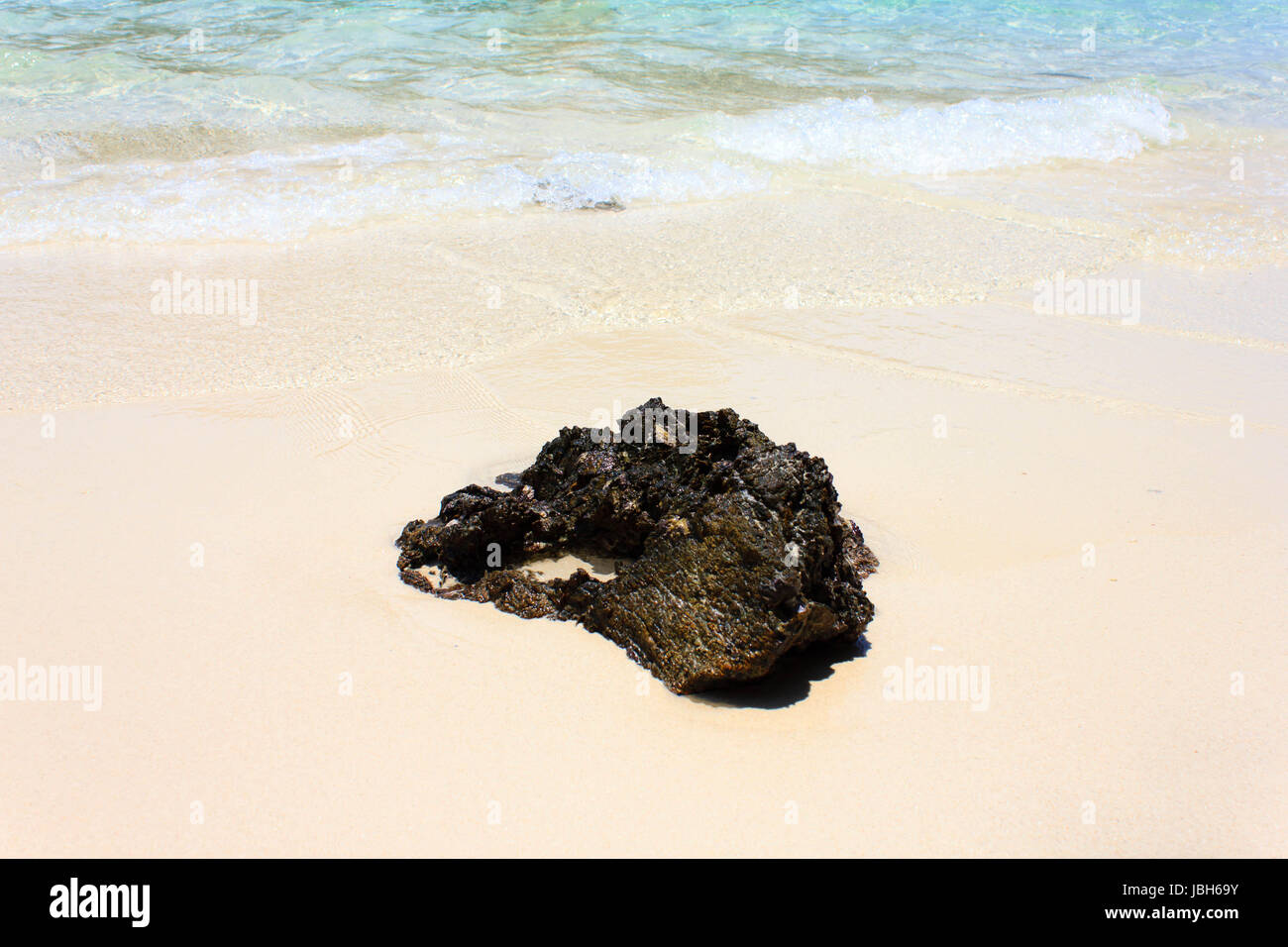 Blue water texture with small stones Stock Photo - Alamy