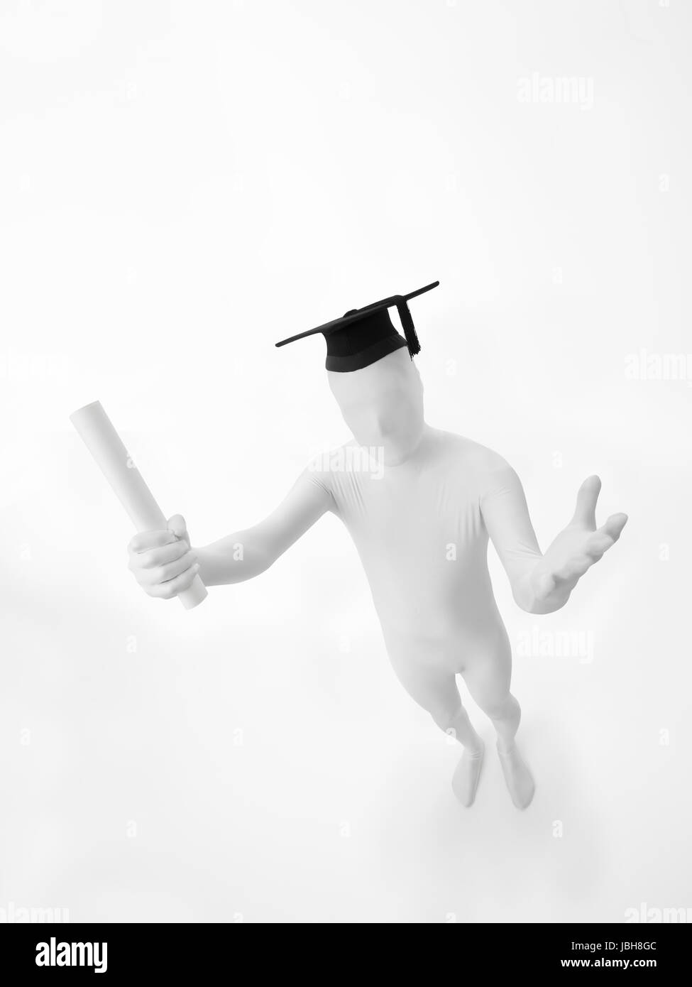 Unknown person dressed in black tie and white suit with graduate hat ...